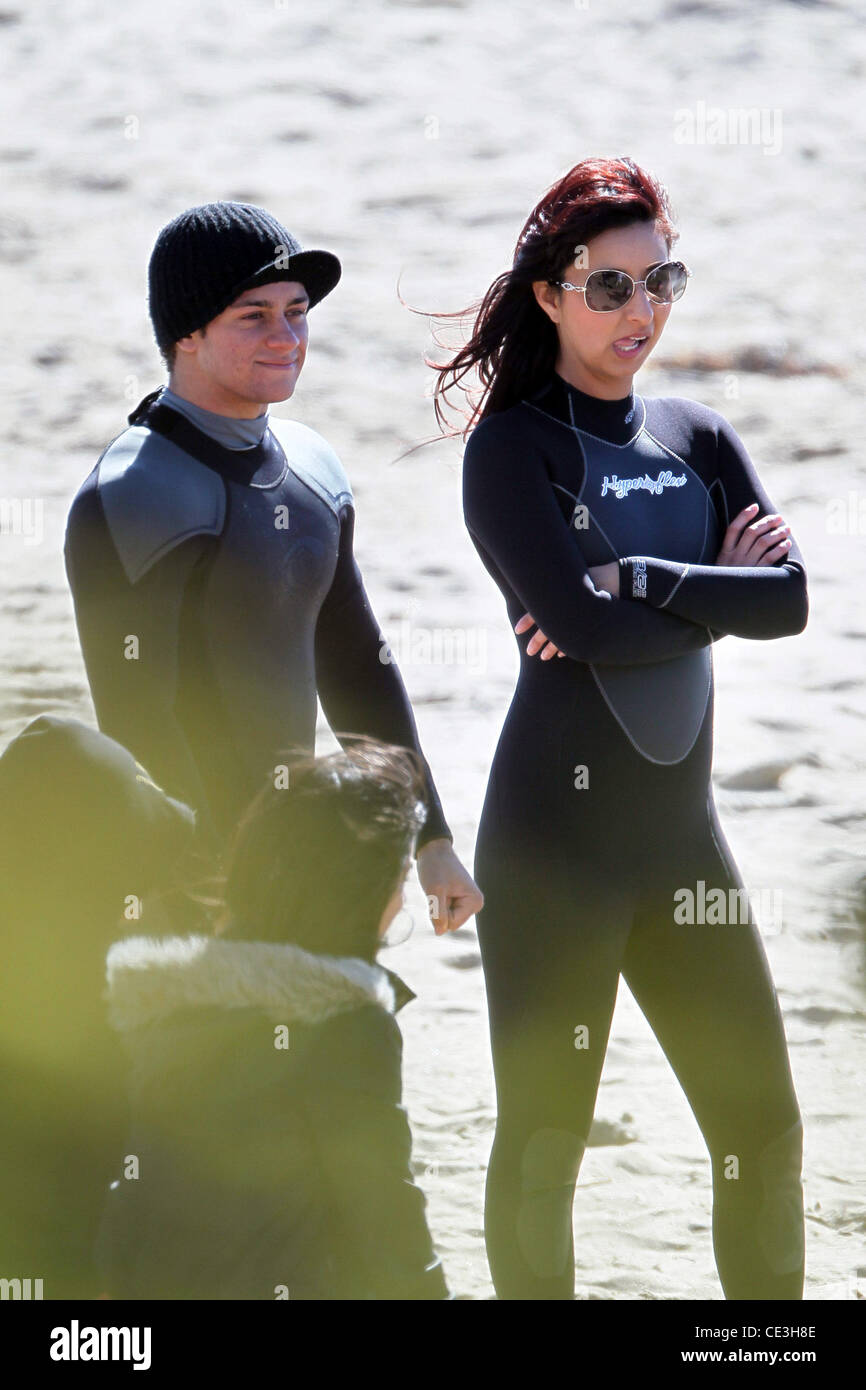 Cast members of the television show '90210' film a beach scene with ...