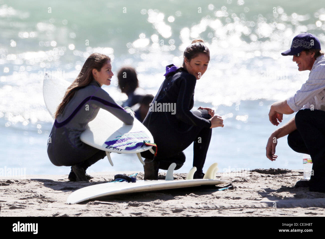 Cast members of the television show '90210' film a beach scene with ...