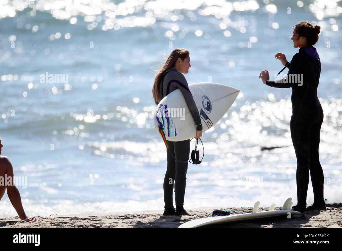 Cast members of the television show '90210' film a beach scene with ...