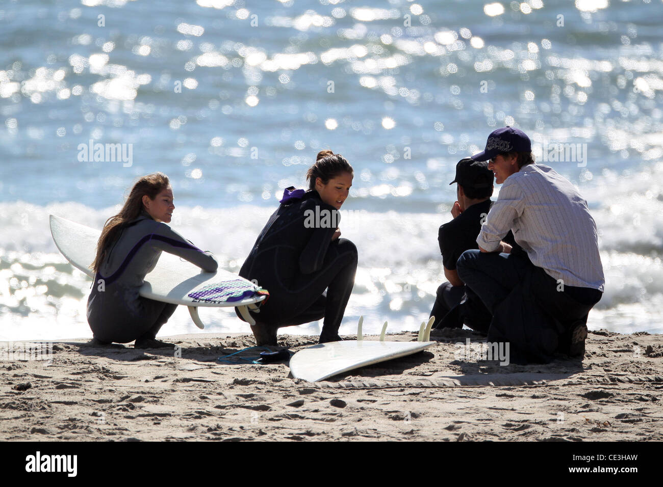Cast members of the television show '90210' film a beach scene with ...