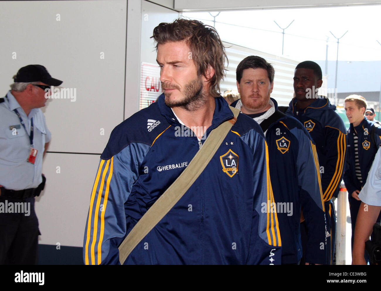 David Beckham is greeted by fans as he arrives at Sydney International ...