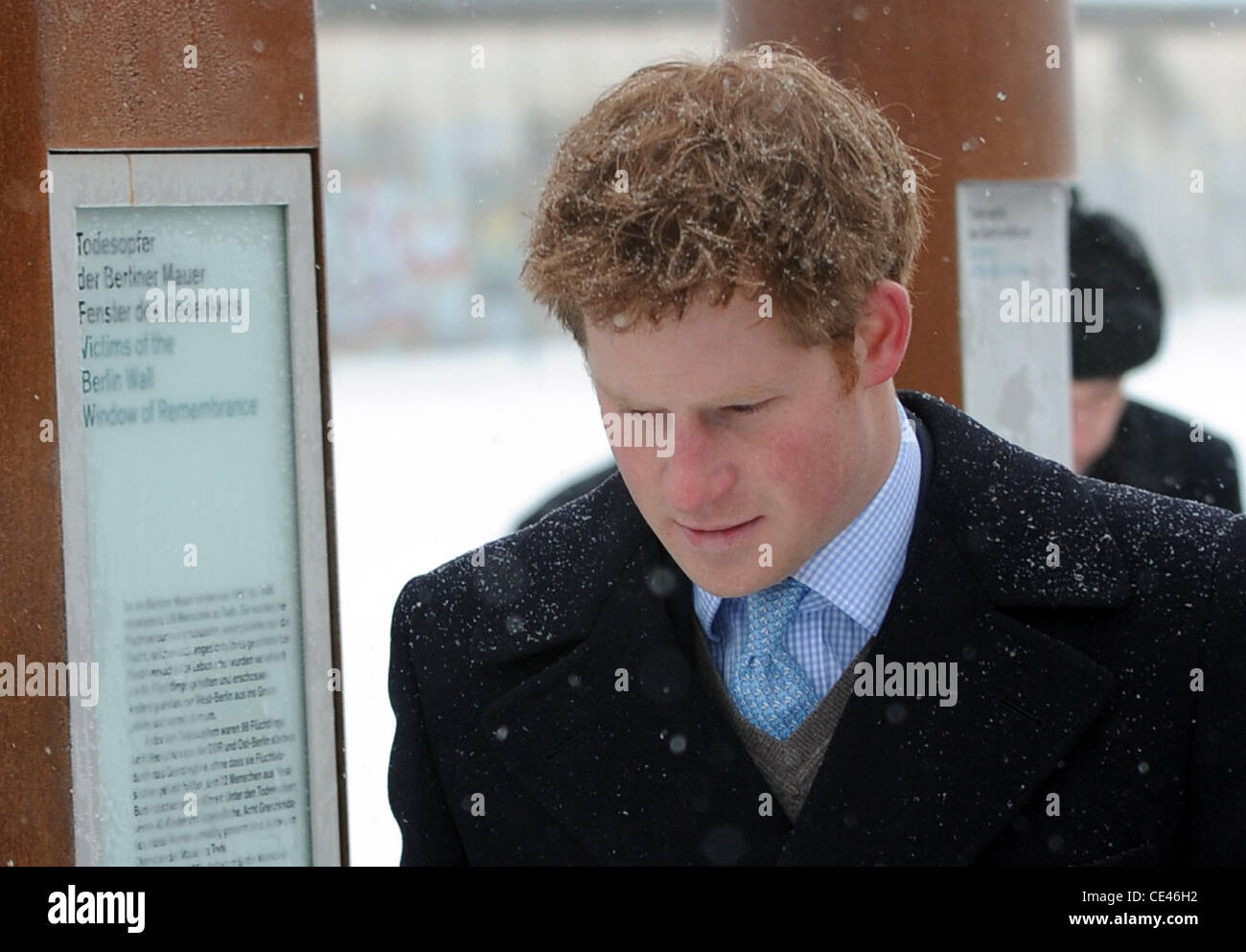 Prince Harry walks through the snow as he visits the Bernauer Strasse ...