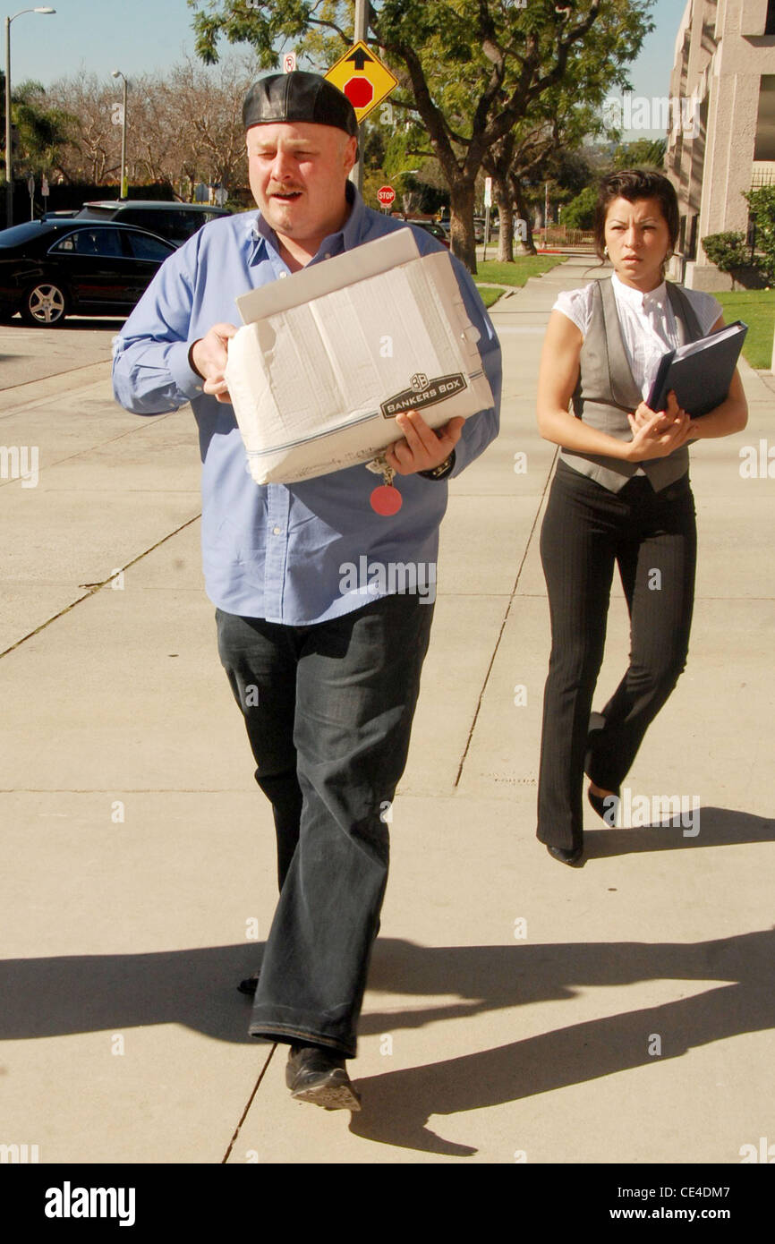 Howard Mann arriving at his lawyer's office carrying a box. Katherine ...