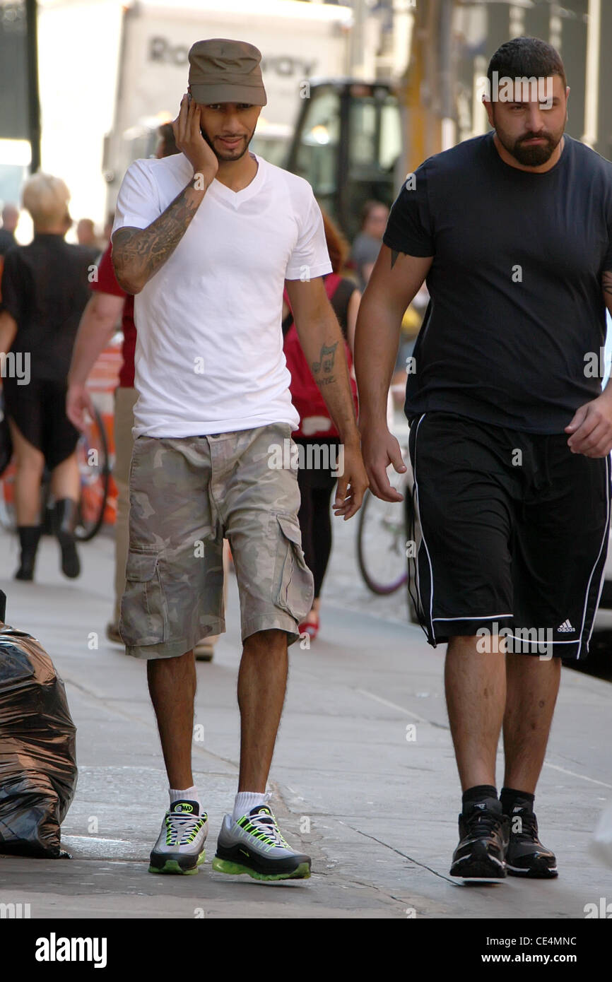Swizz Beatz aka Kasseem Dean talking on his cell phone while walking to ...