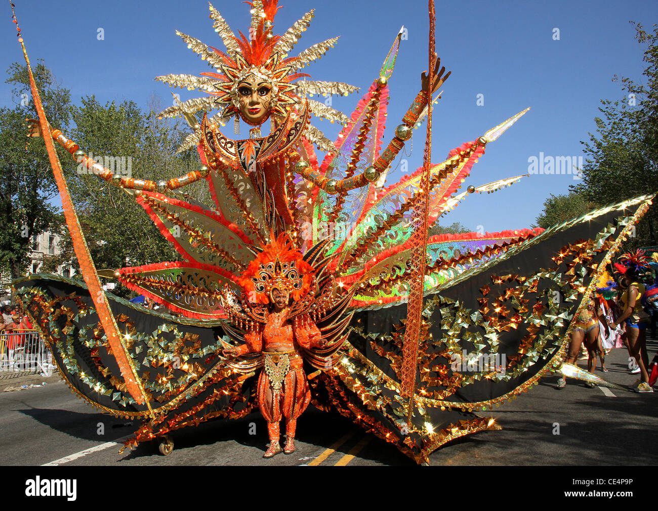 Parade participants dressed in colorful costumes dance in the 2010 West ...