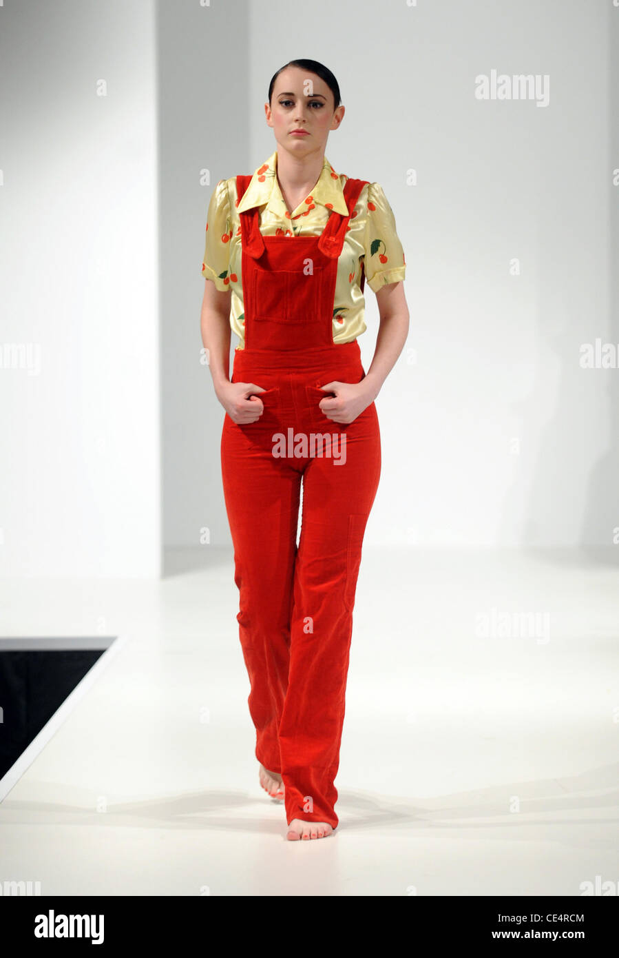 A model walks the catwalk in vintage clothing at a fashion show during ...