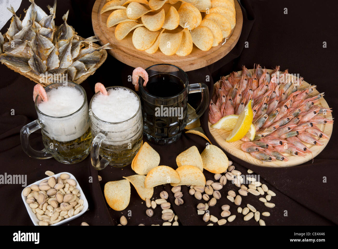 Beer and snacks set: chips, pistachio, shrimp and fish Stock Photo - Alamy