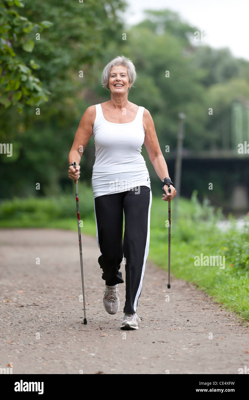 Active senior woman walking in the park Stock Photo - Alamy