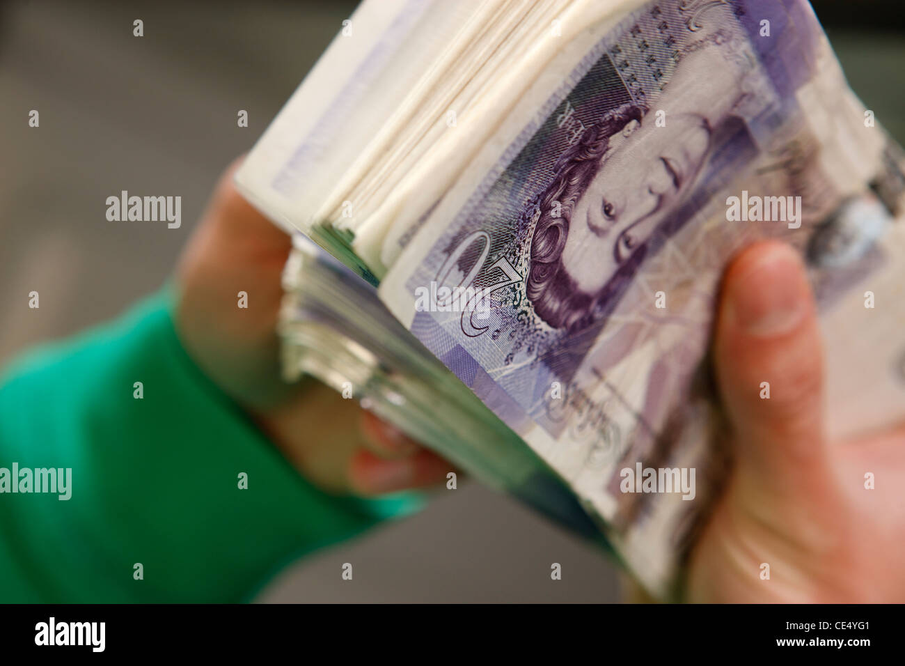 holding fan money £20 notes GBR sterling currency view landscape young ...