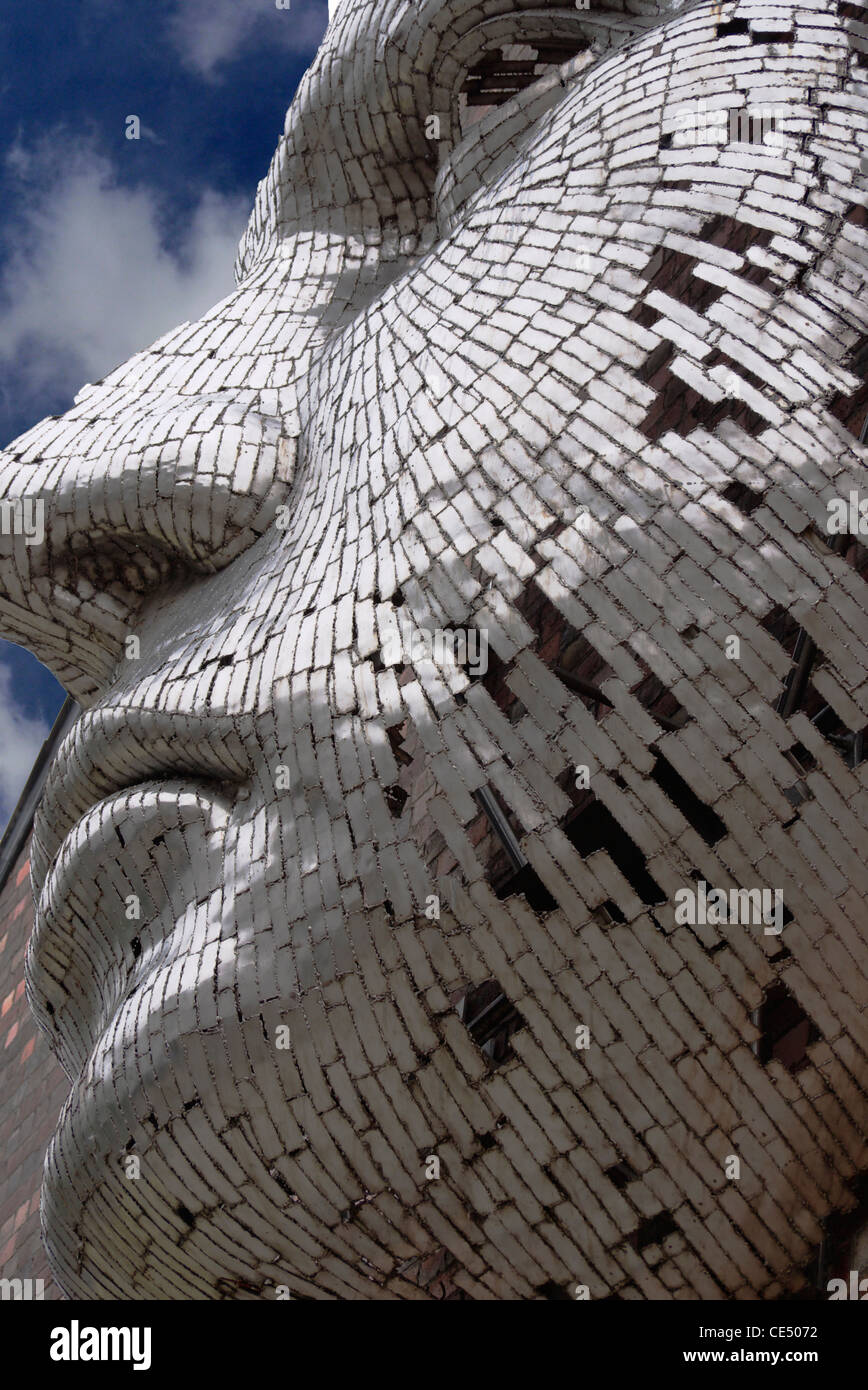 This is the sculpture depicting a massif metal face attached to a wall ...
