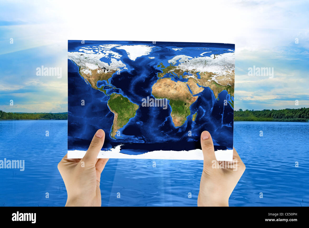 Hand holding map at beauty sunset on river background Stock Photo - Alamy