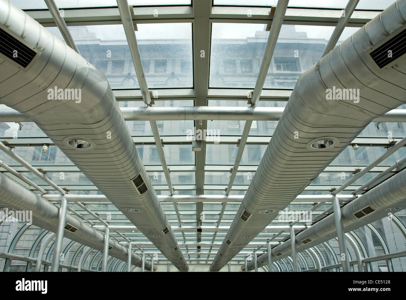 Air conditioning ducts in an above-street covered walkway, linking two ...