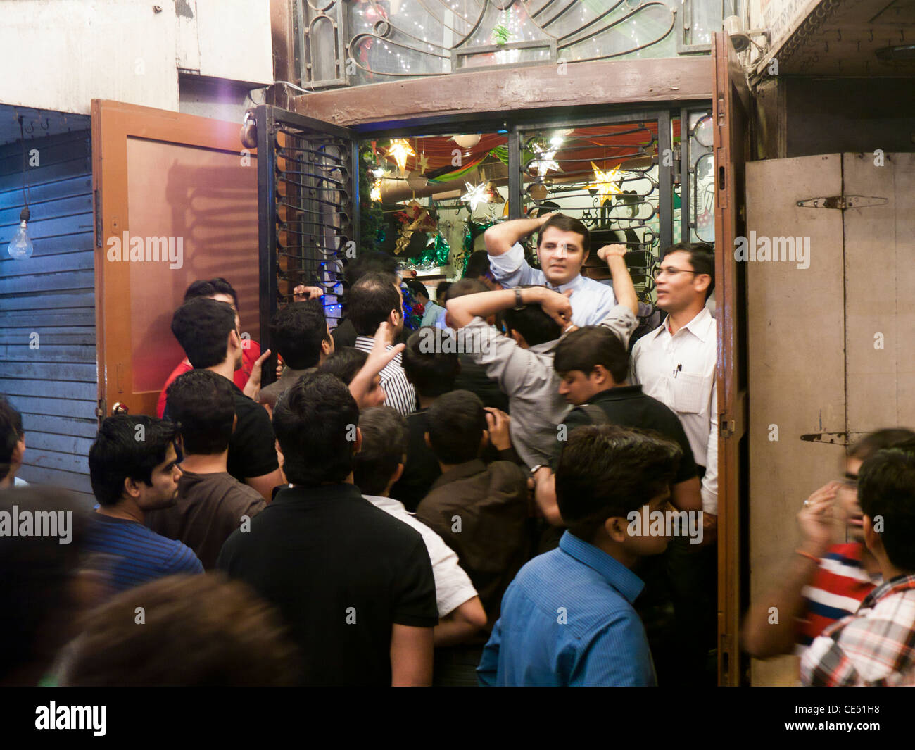 People queue outside a bar in Colaba in Mumbai India on New Years Eve ...
