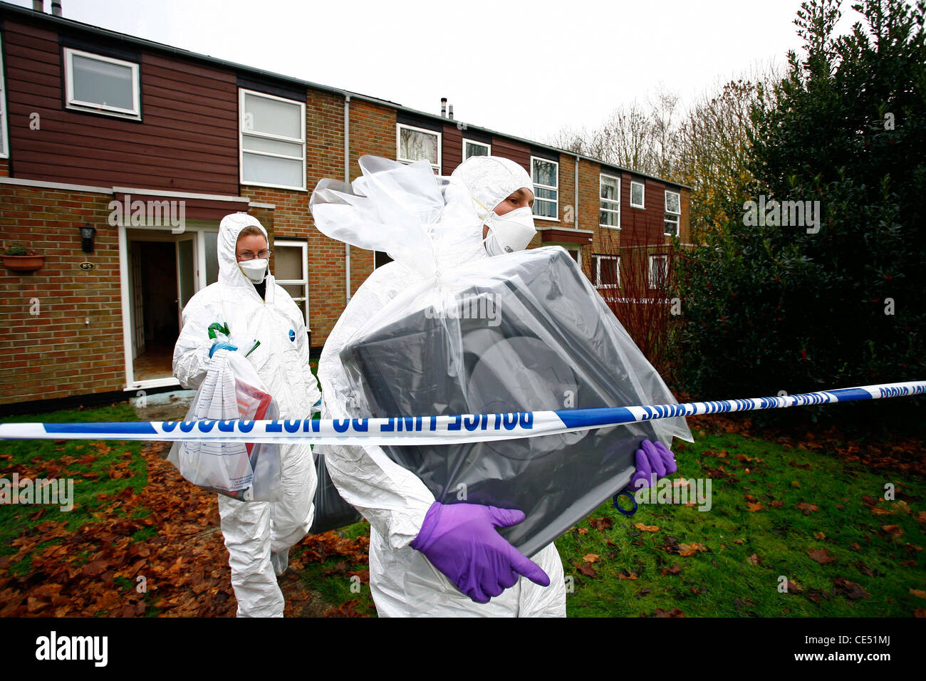 Scene Of Crime Officers remove a computer from a crime scene. Picture ...
