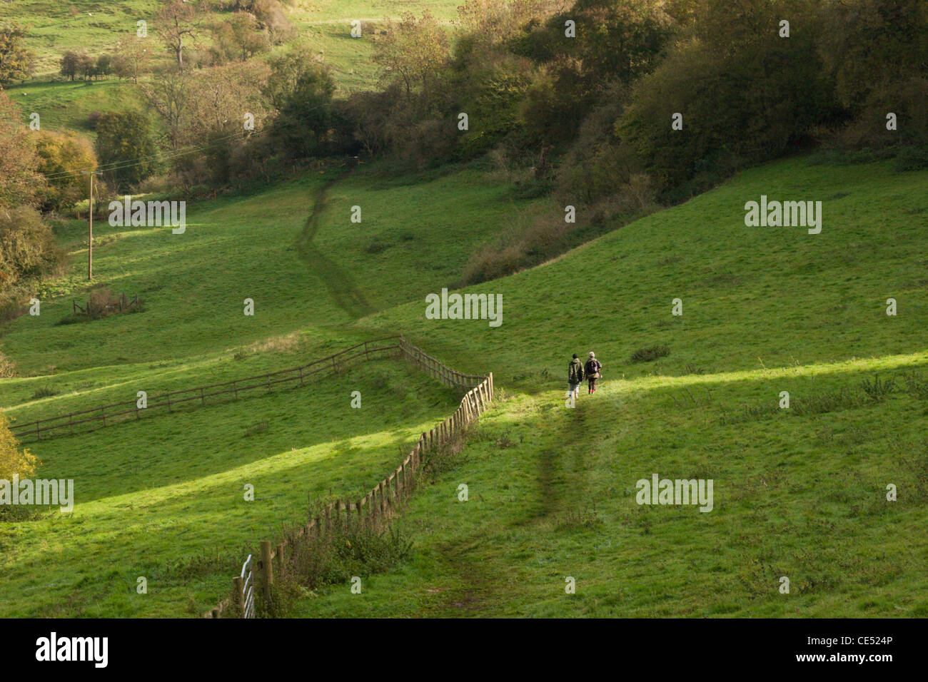Walkers crossing fields near Snowshill in the Cotswolds, UK Stock Photo ...