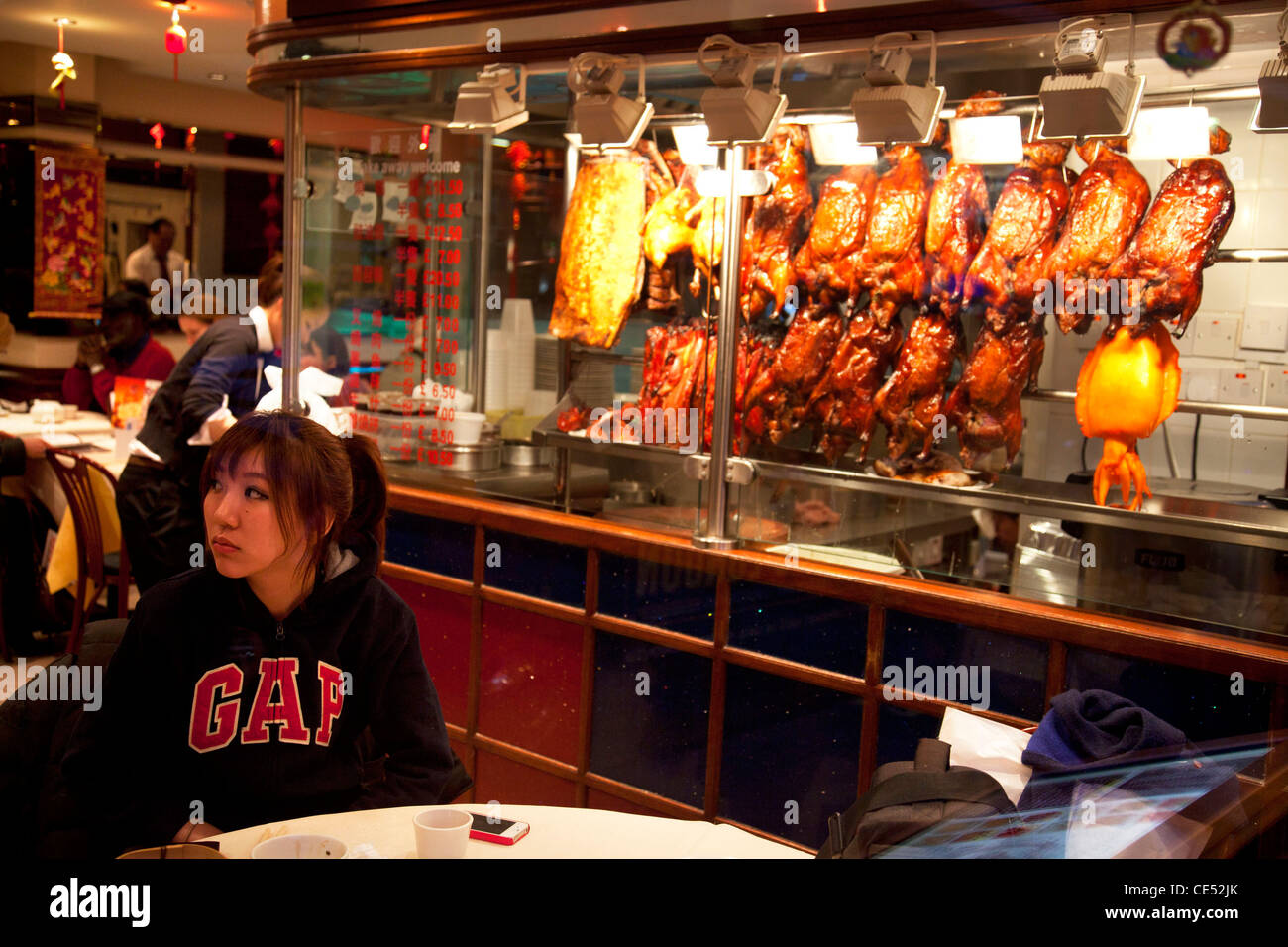 Girl waiting at a Chinese restaurant in London's Chinatown Stock Photo ...