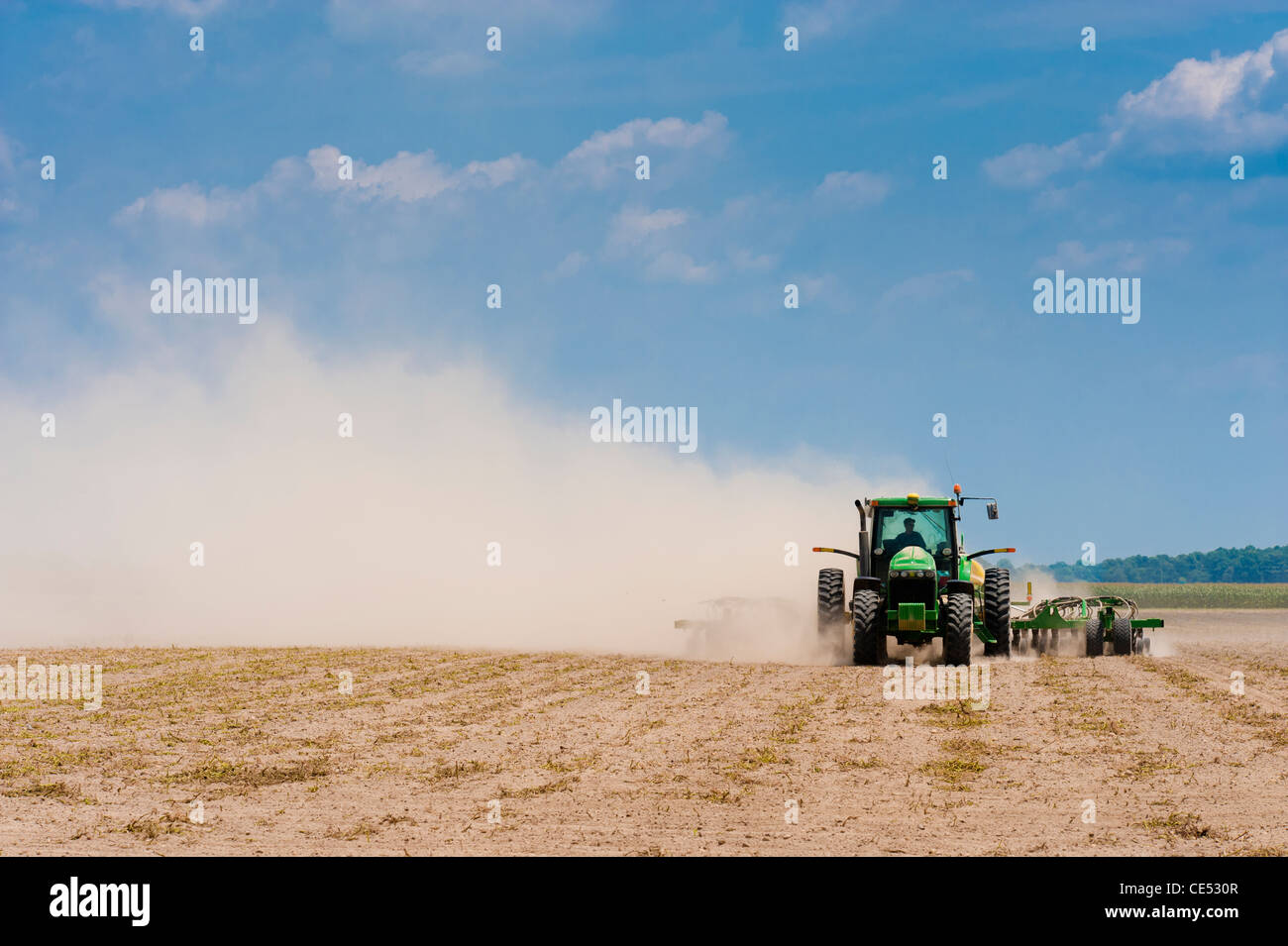 Chemical application by tractor on dusty field of farm near Hurlock, MD ...
