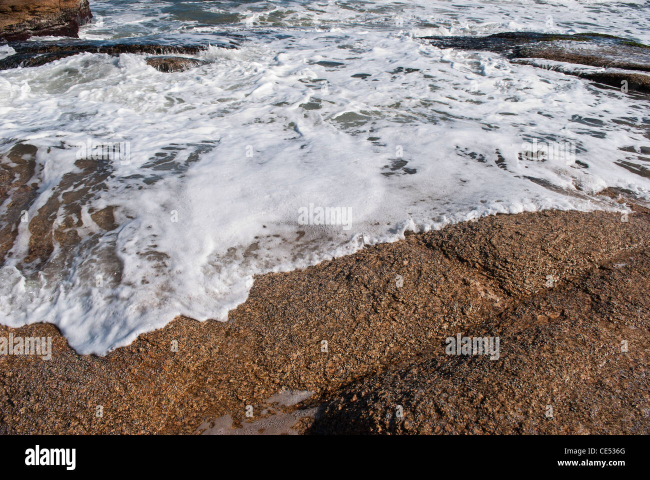 foam of sea on rocks Stock Photo - Alamy