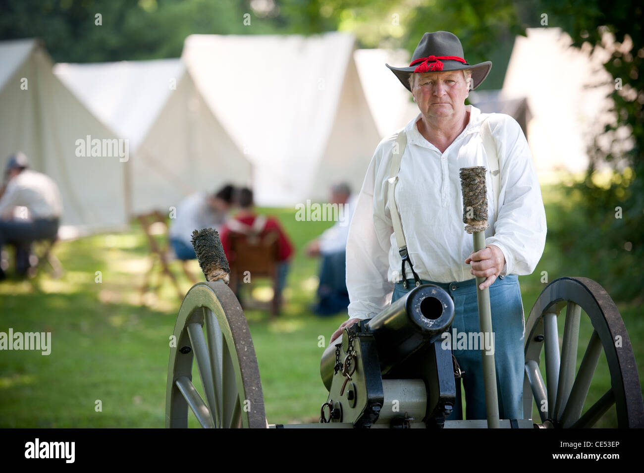 Civil War reenactor standing beside canon replica and Civil War ...