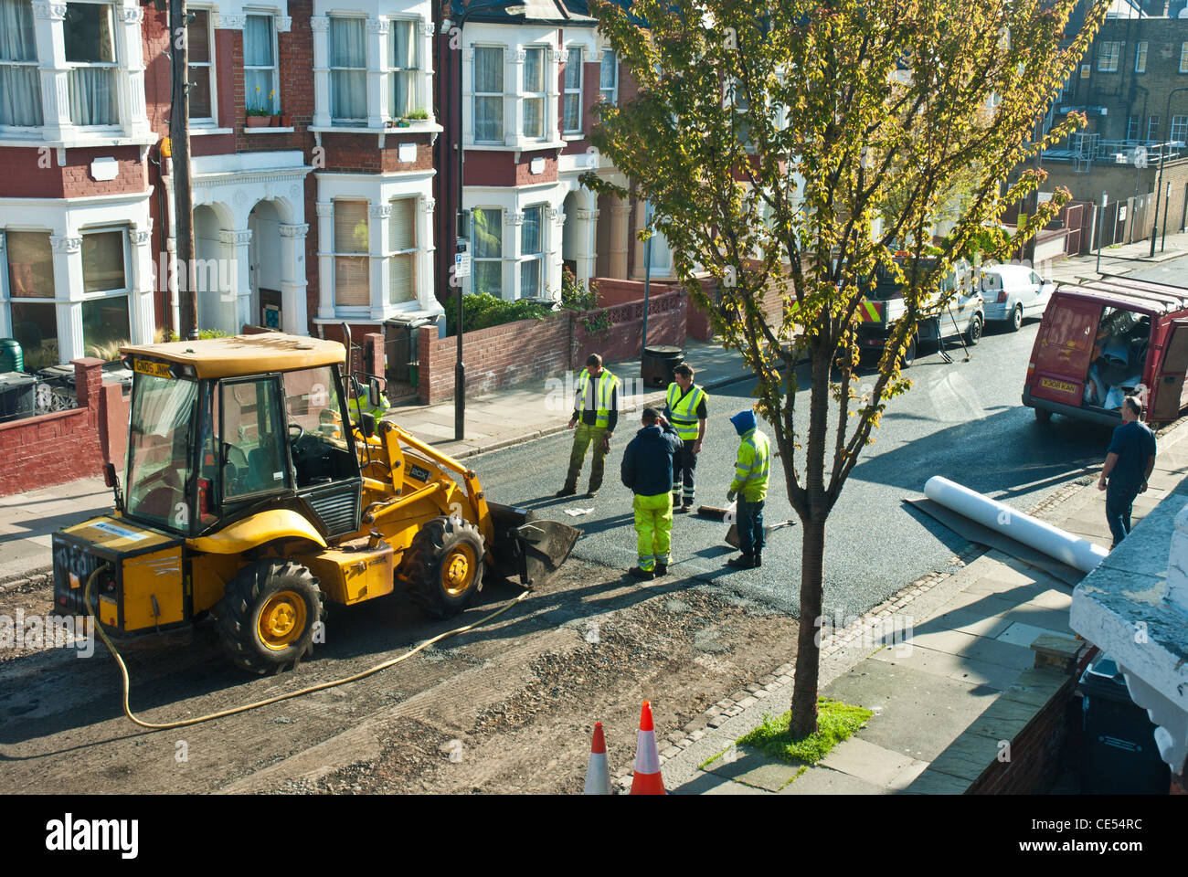 Resurfacing a suburban street, road digger shot from high vantage point ...