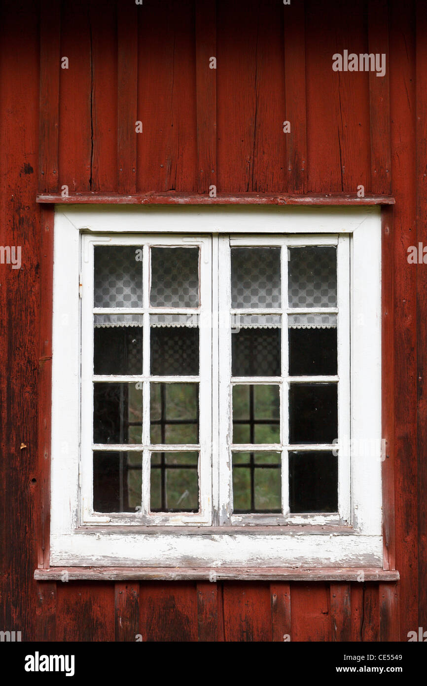 old weathered window at a red cottage Stock Photo - Alamy