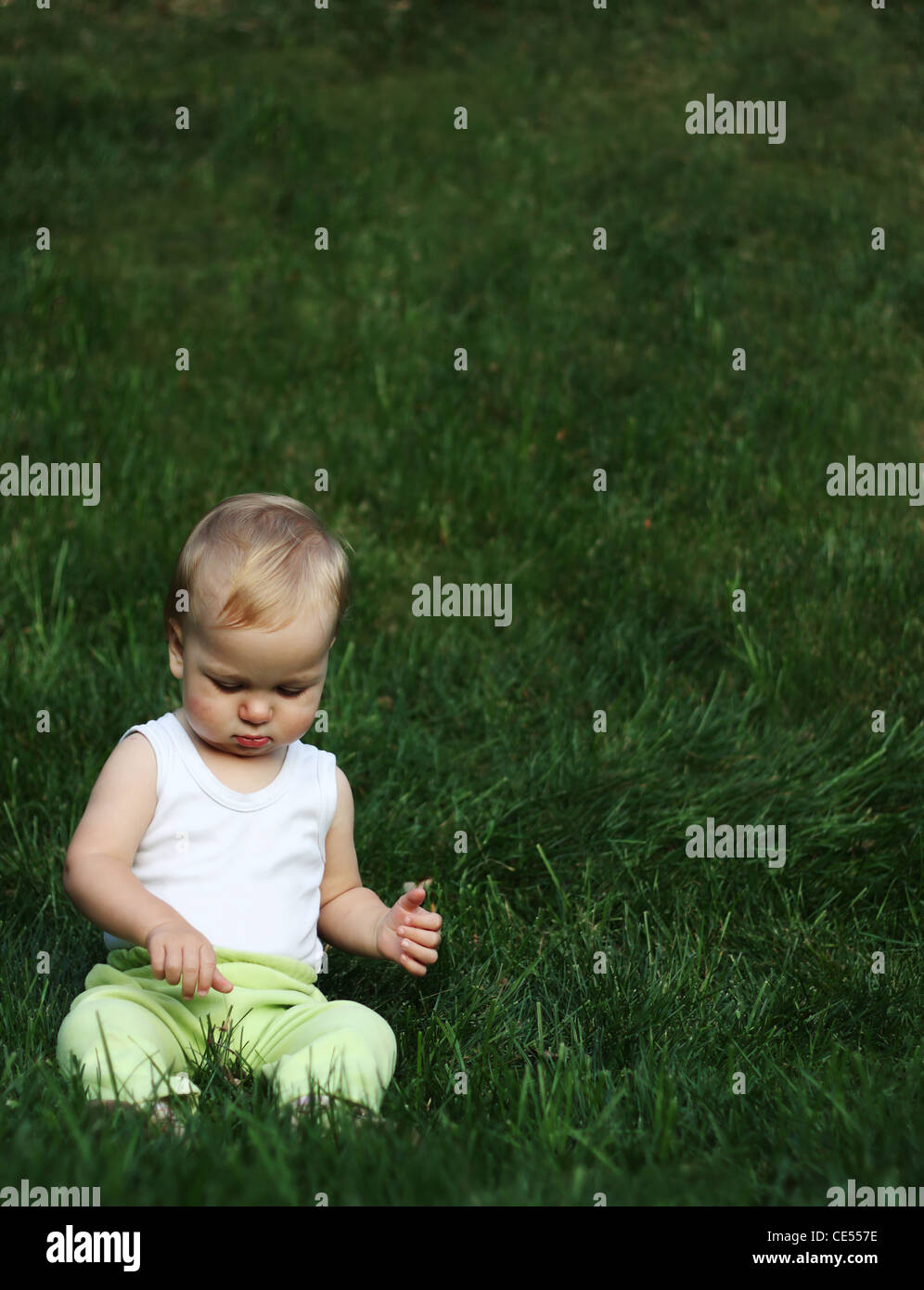 Boy sitting on the grass Stock Photo - Alamy