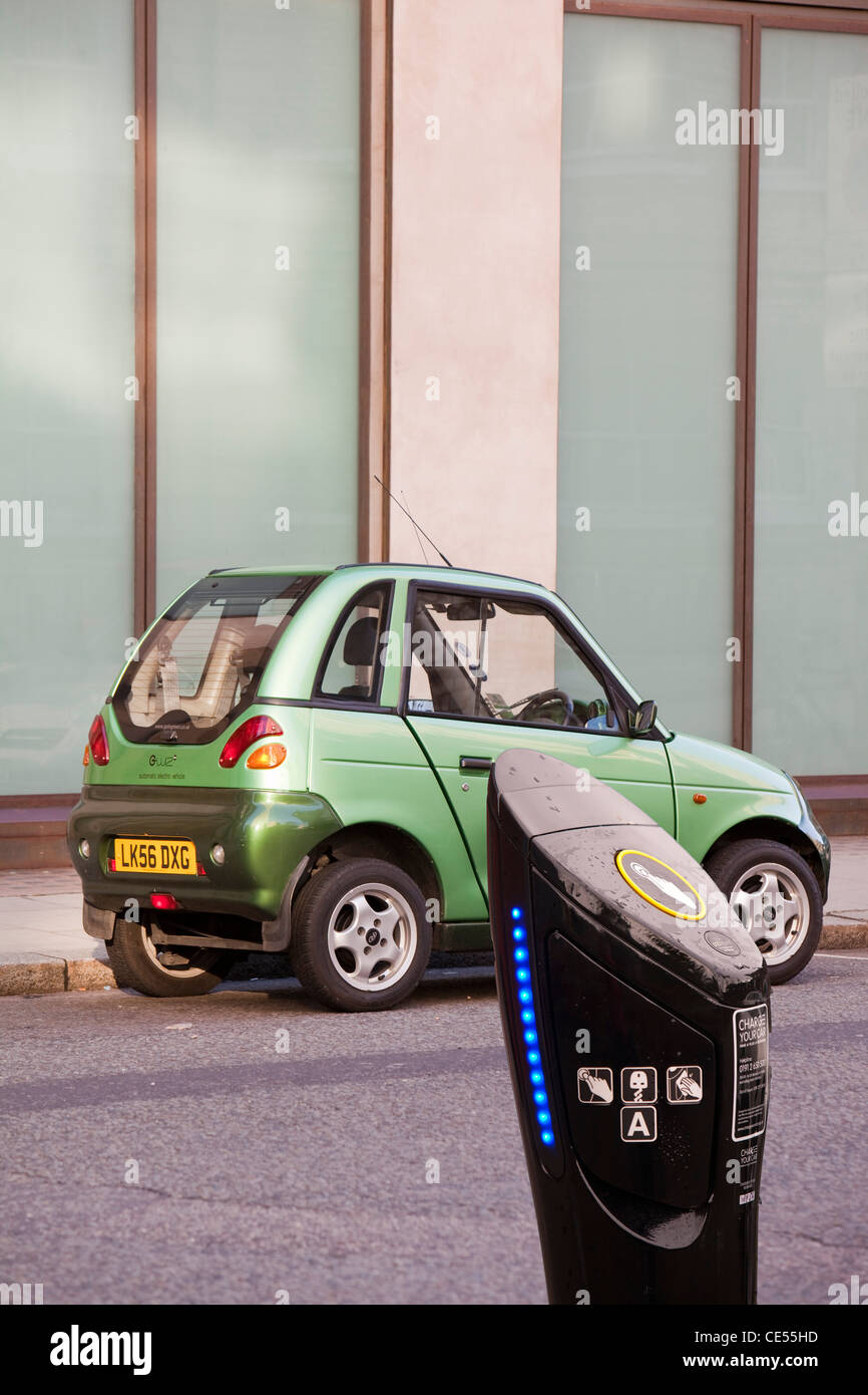 A G-Wiz electric car on the streets of London, UK and a recharging ...