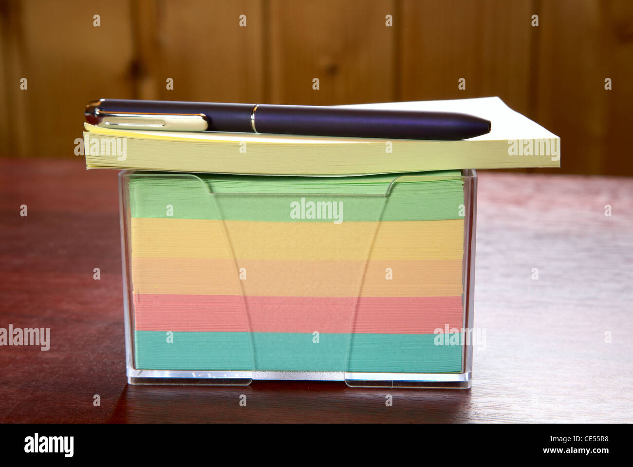 Pen and the block of stickers on a desk Stock Photo - Alamy