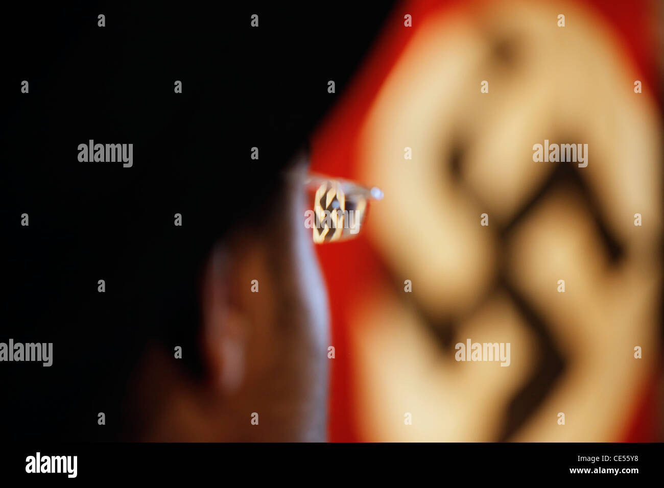 A Haredi Jew looks at an exhibit of Nazi swastikas in Yad Vashem, the ...