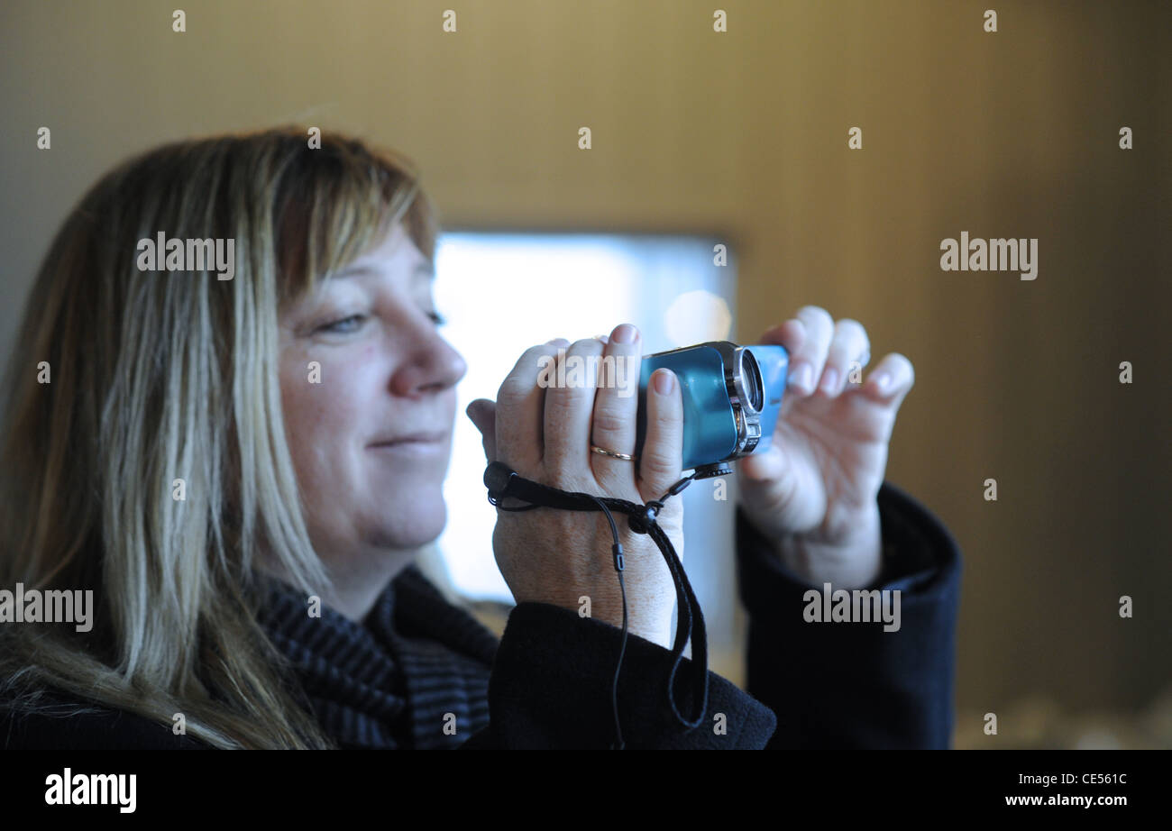 Woman using a small hand held Sanyo high definition video camera Stock ...