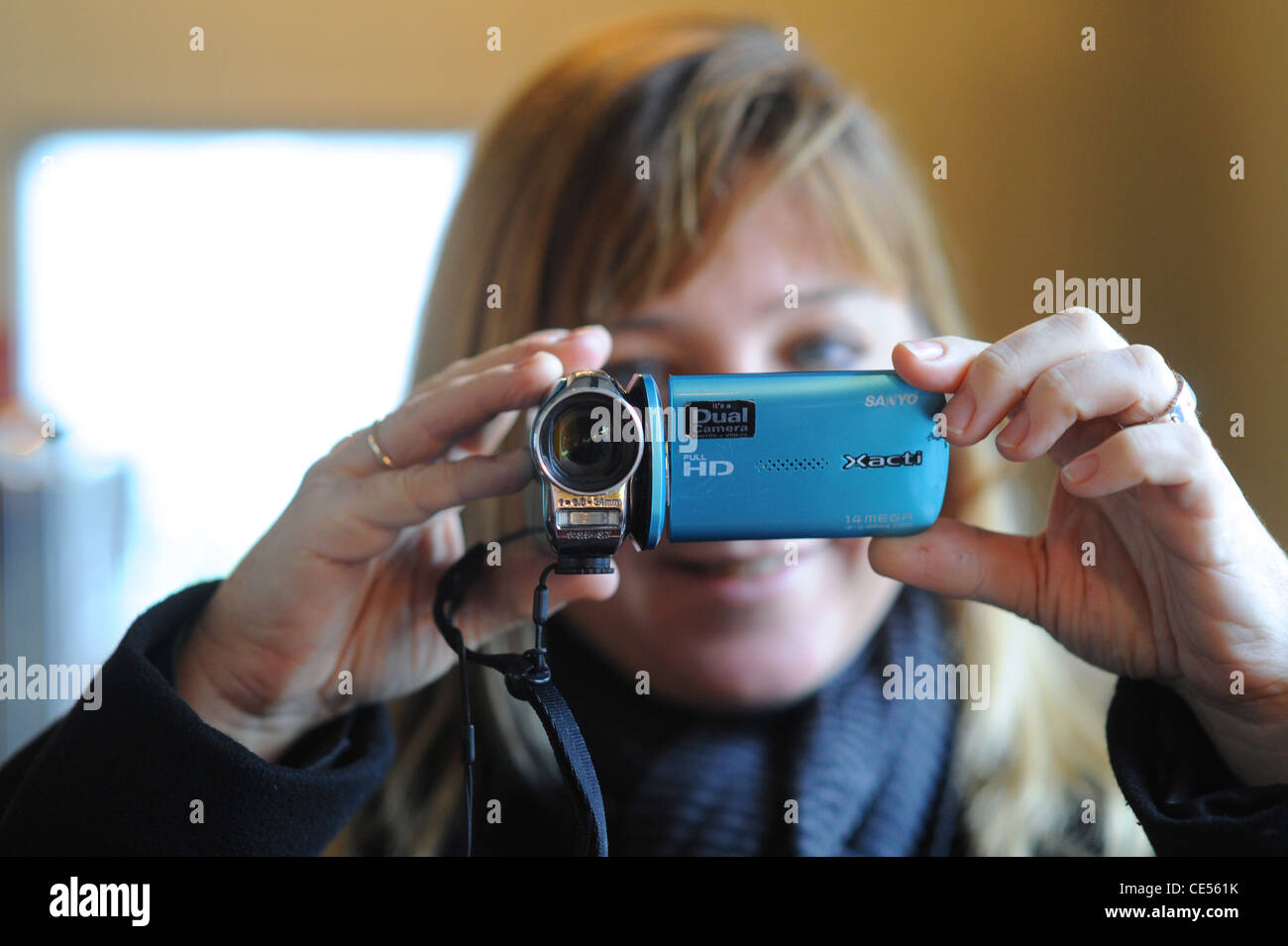 Woman using a small hand held Sanyo high definition video camera Stock ...