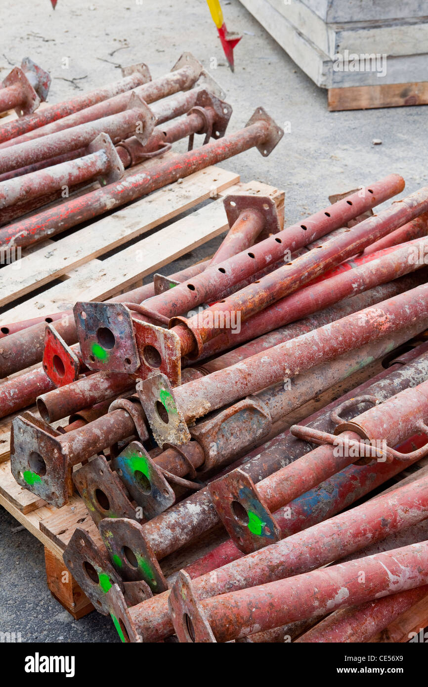 Steel acro props lying in wait on a building site Stock Photo - Alamy