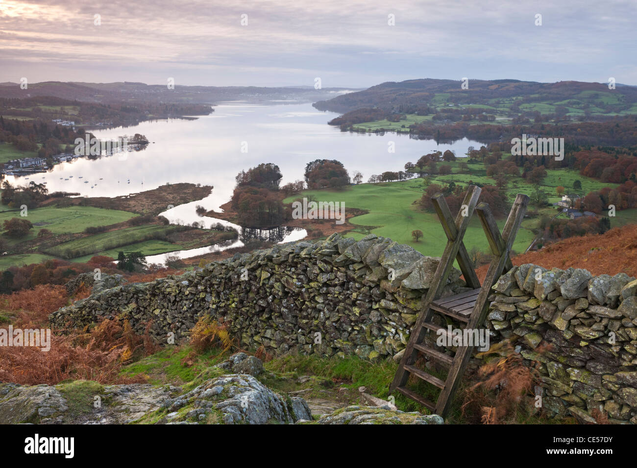 Dry stone wall and wooden stile above Lake Windermere, Lake District ...