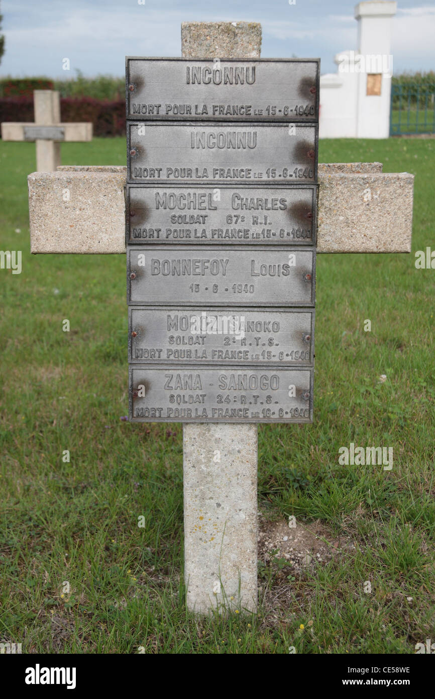 Close up of name plates on a mass grave cross marker in the La Ferme de ...