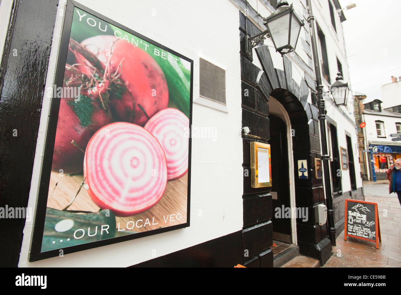 An advert for local food on a pub in Keswick, Cumbria, UK Stock Photo ...