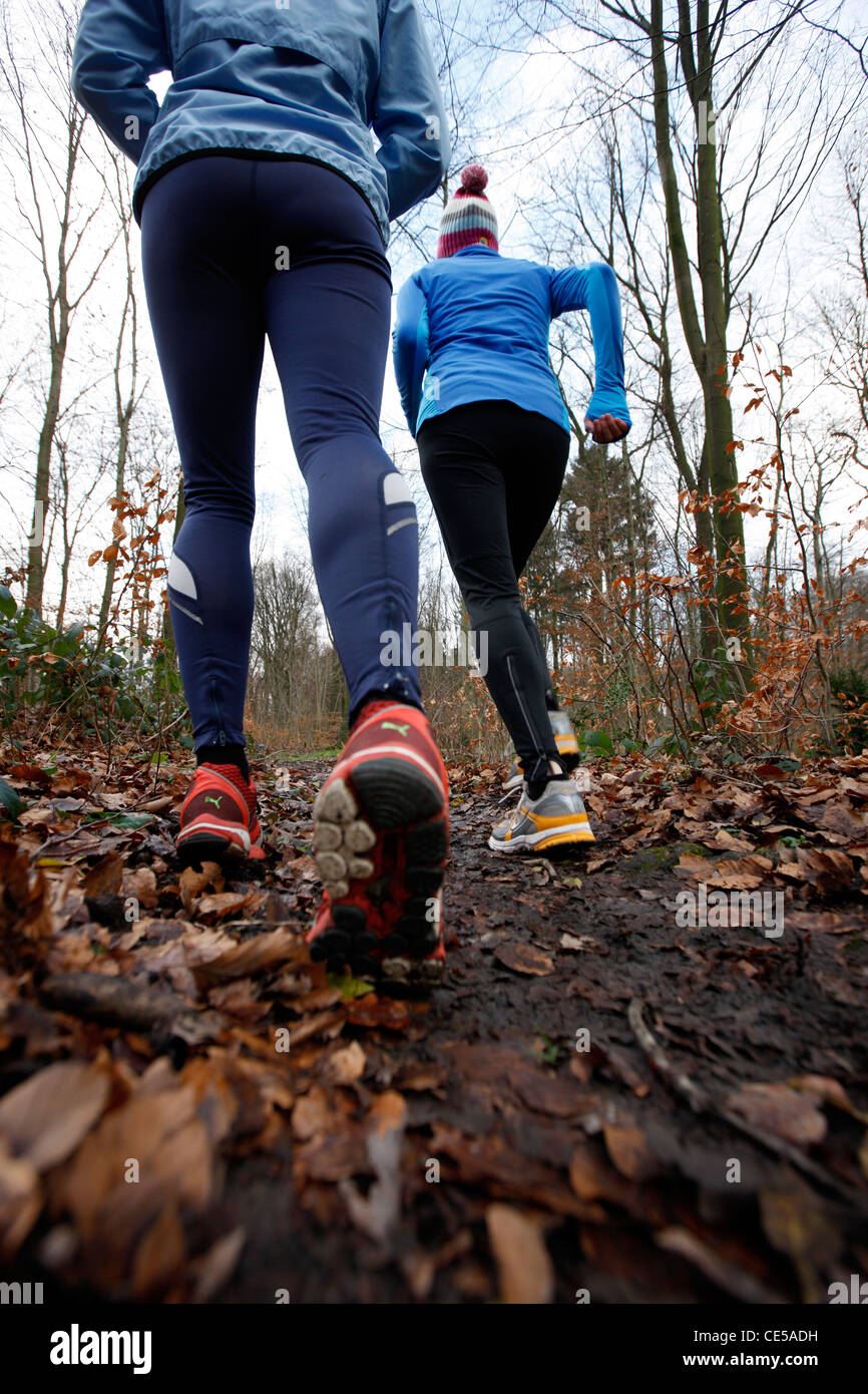 2 young women jogging in winter, in a forest Stock Photo - Alamy
