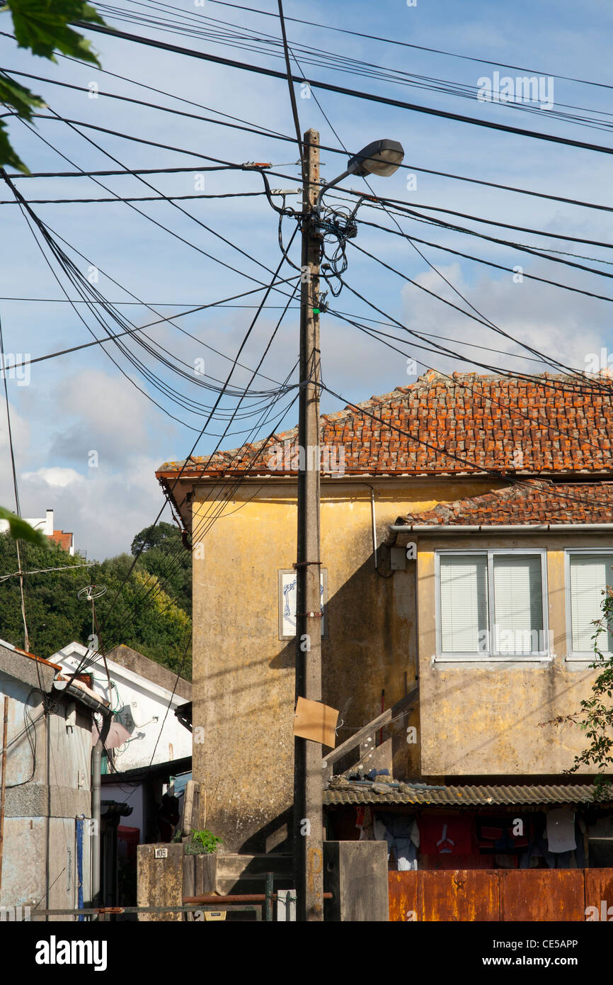Lamp post and high quantity of power cables hanging through a small ...