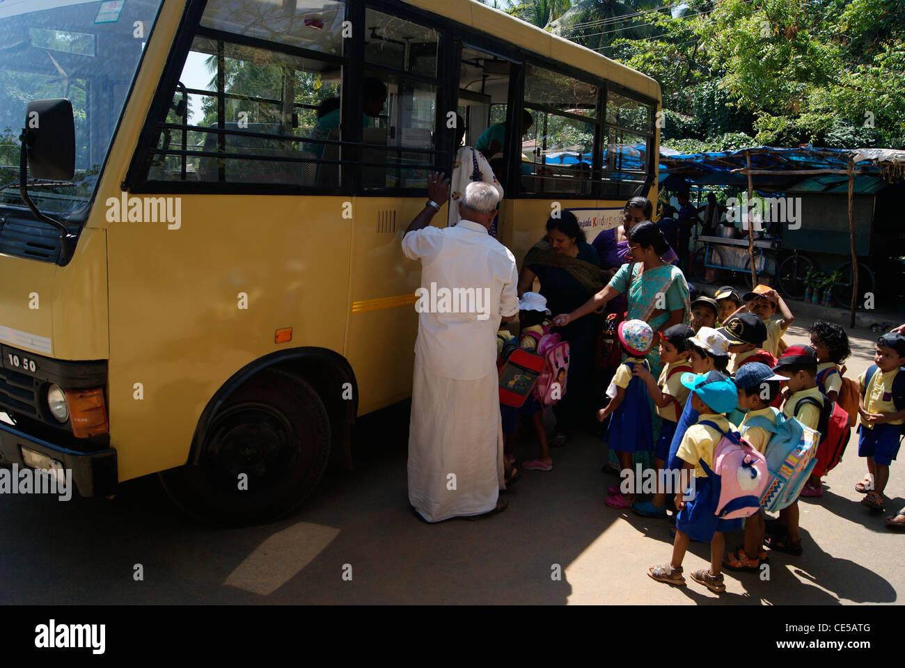 Lot of Small Nursery School children entering in school Bus and ...