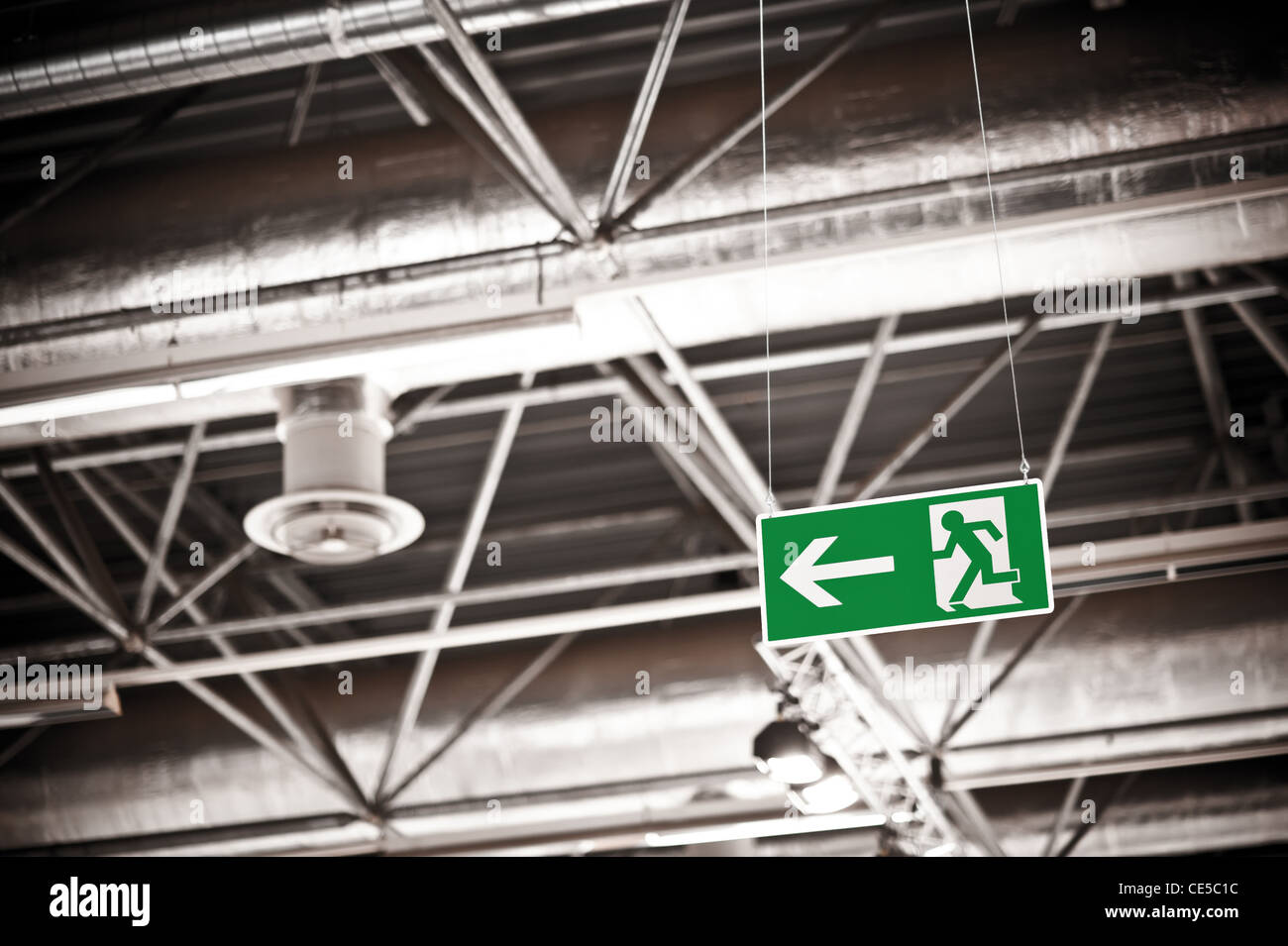 Emergency exit sign under the ceiling of a fair hall Stock Photo - Alamy