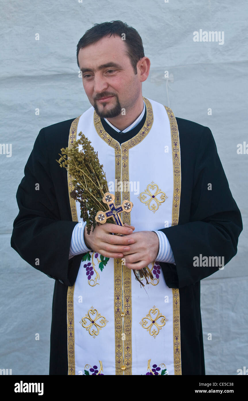 Greek orthodox priest participates in the baptizing ritual during the ...
