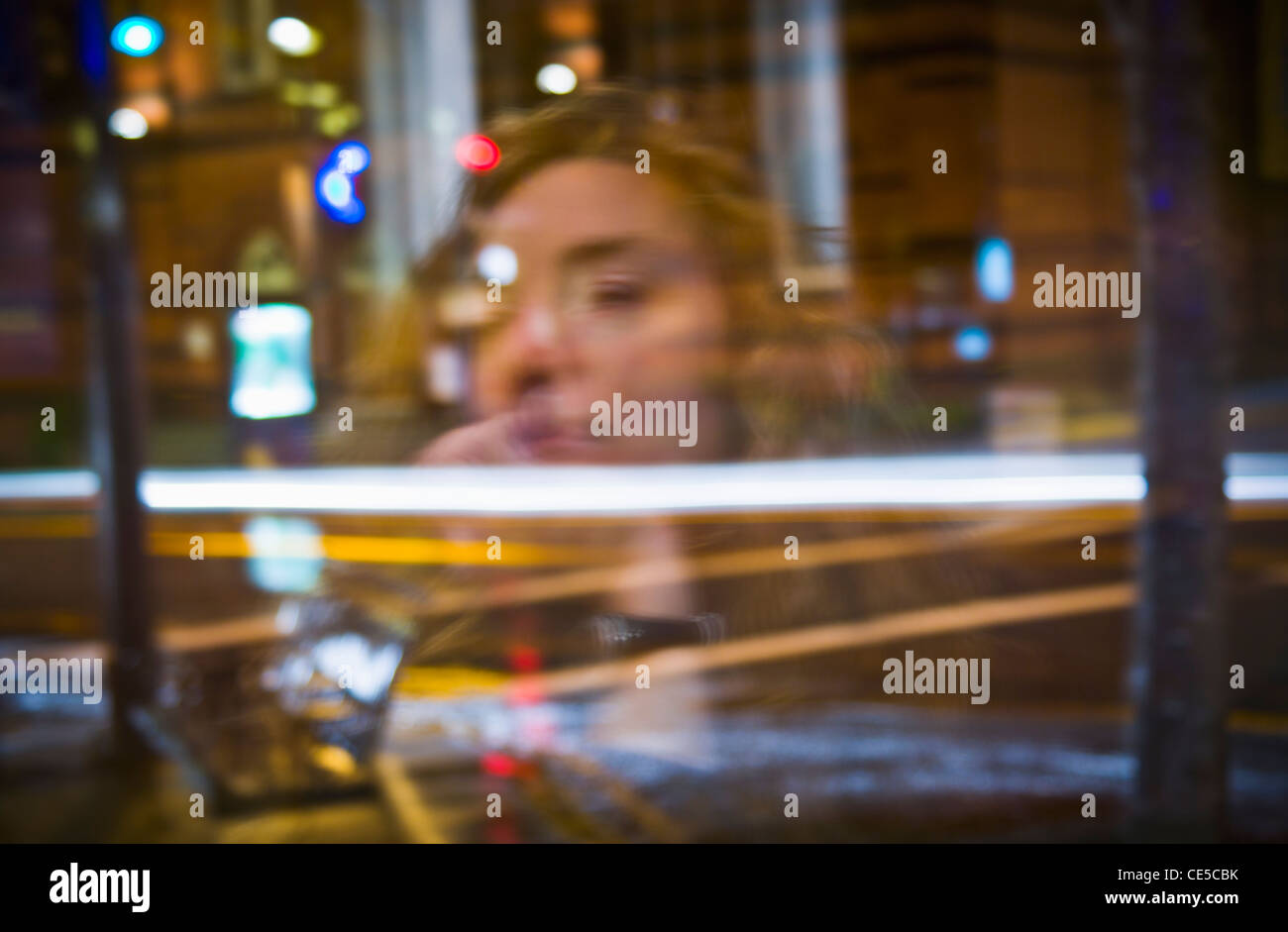 A woman reflected in a window at night Stock Photo - Alamy
