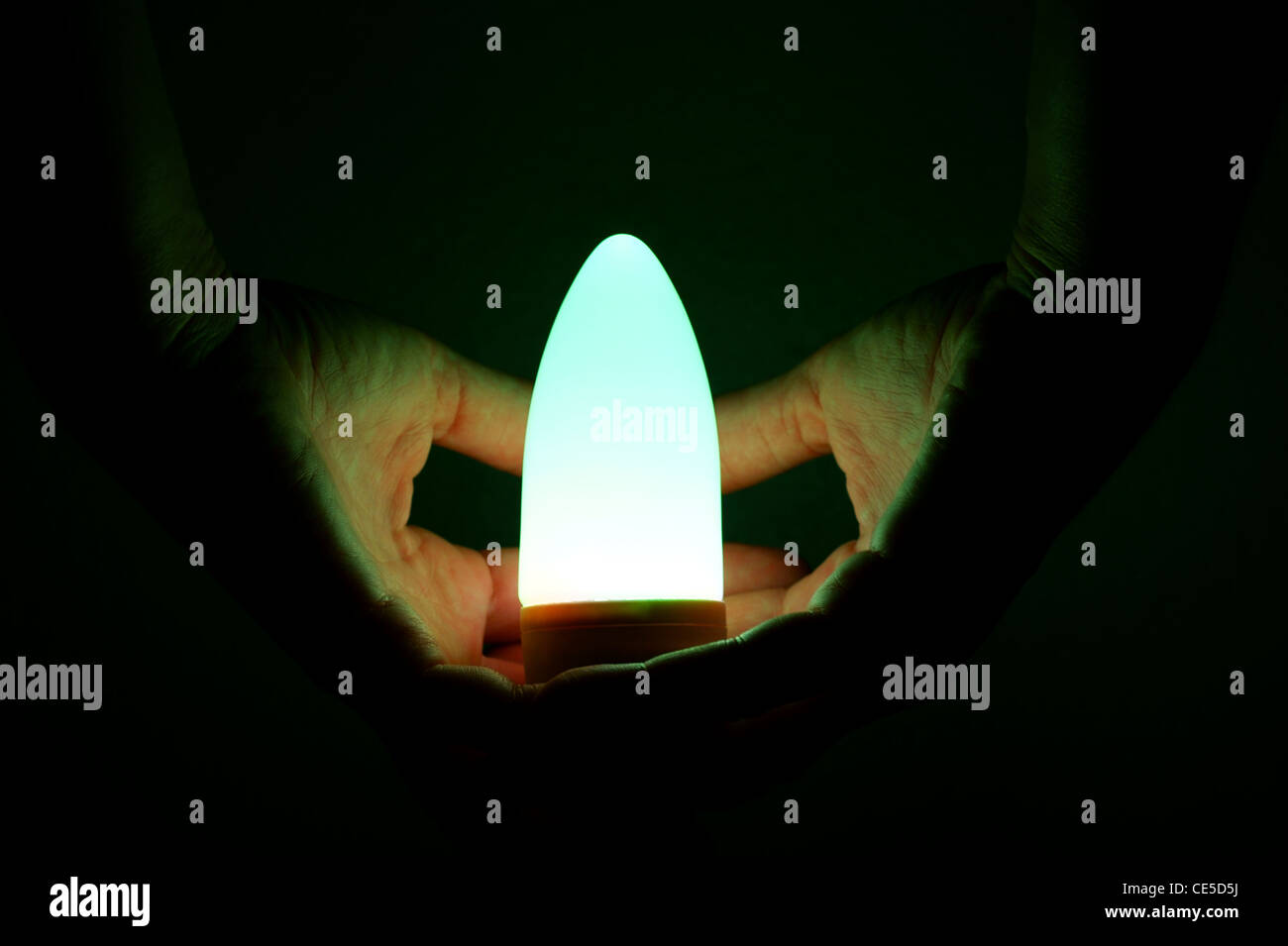 hand security luminous bulb on black background Stock Photo - Alamy