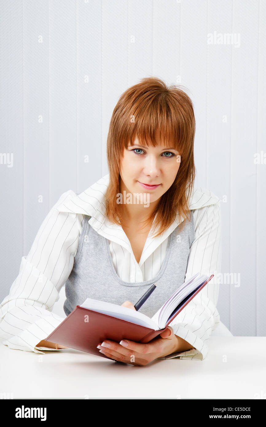Attractive girl with a notepad and pen Stock Photo - Alamy