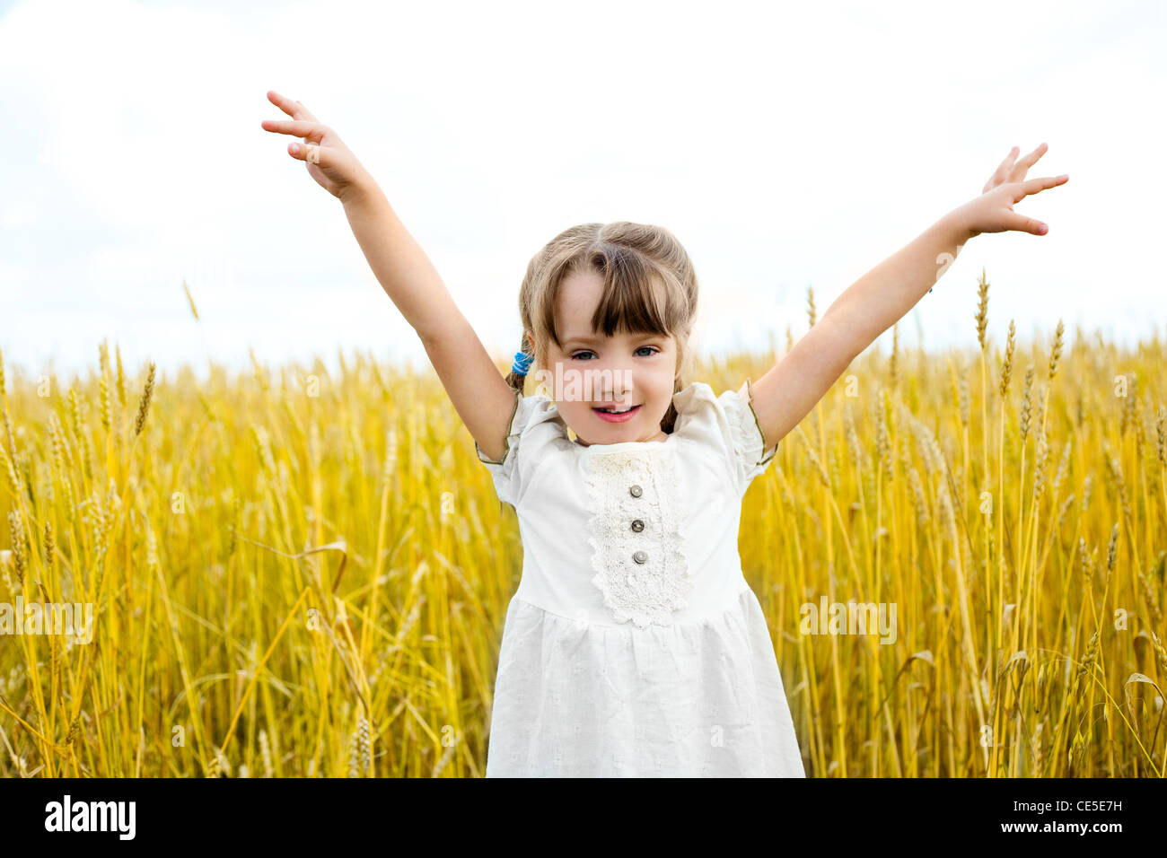 cute happy little girl in the wheat field Stock Photo - Alamy