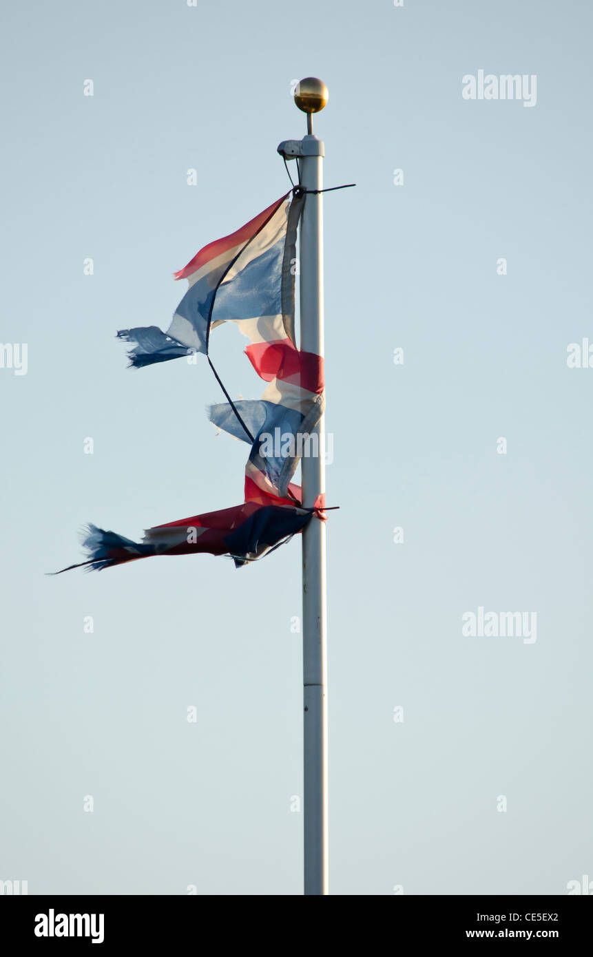 Very old flag flying Stock Photo - Alamy