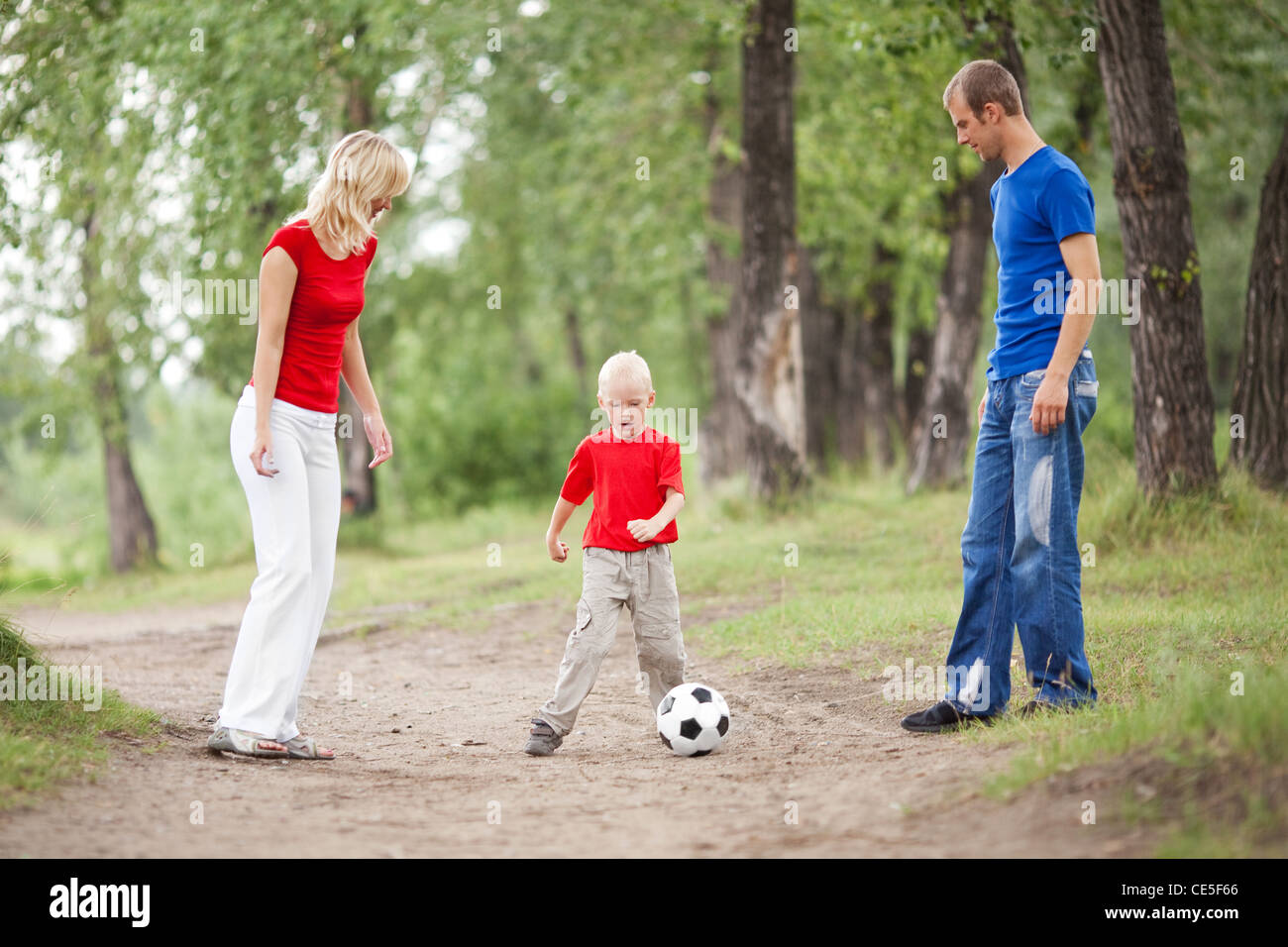 happy young family spending time outdoor on a summer day and playing ...