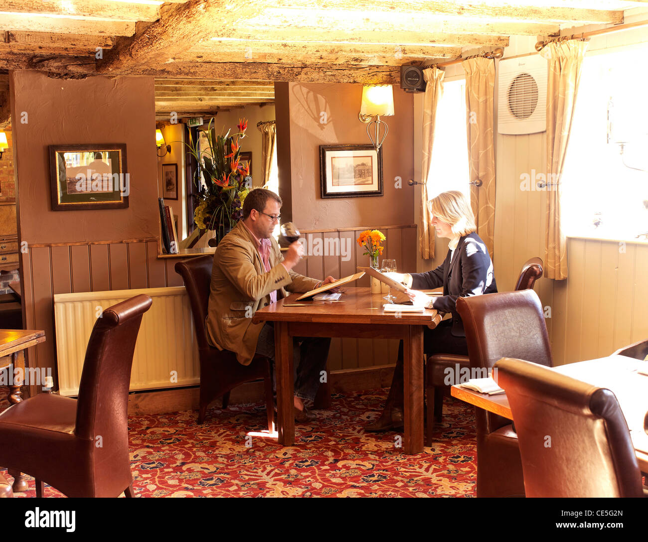 a couple read restaurant menus Stock Photo - Alamy
