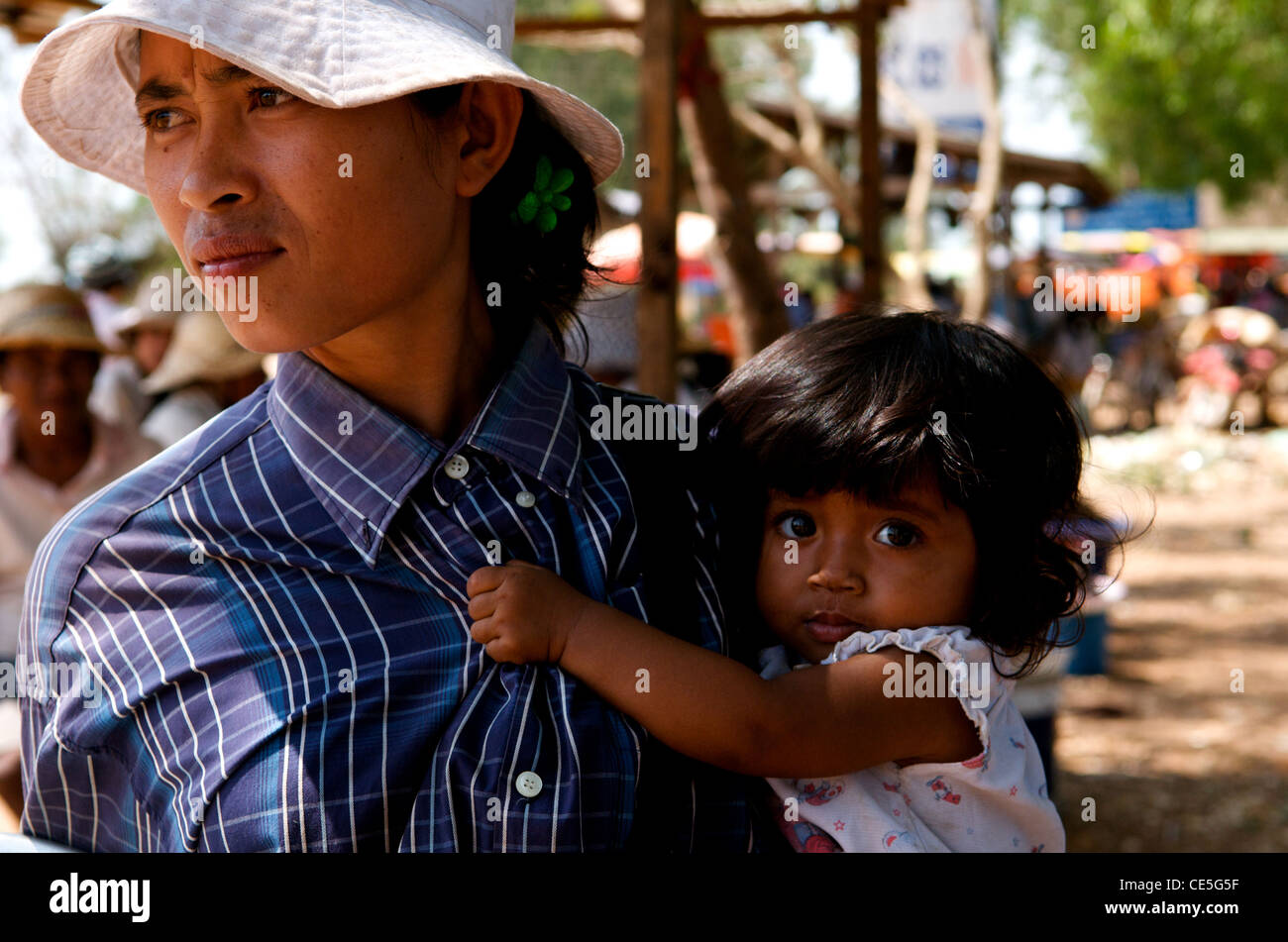 Khmer mother holding Daughter w/ big eyes, Kampong Cham Province, Cambodia. credit: Kraig Lieb ...
