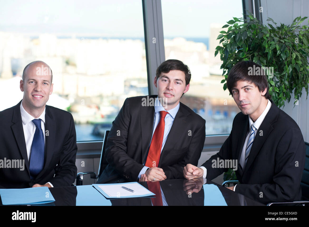 Successful business men at the office table Stock Photo - Alamy