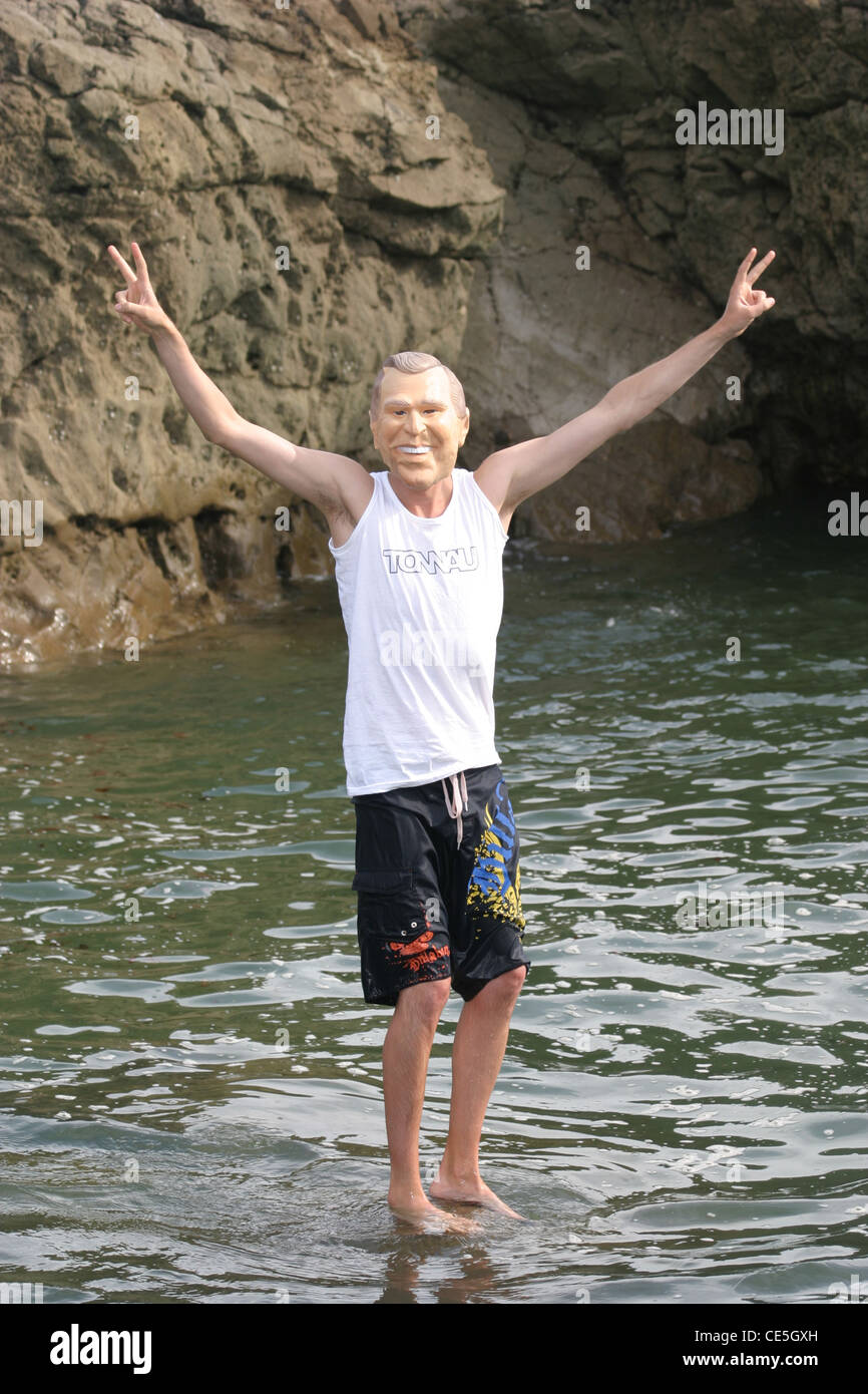 George Bush character walking on water with arms raised giving the ...